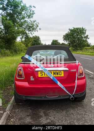 Police tape over a car giving instruction not to cross Stock Photo - Alamy