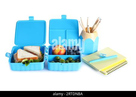 Stationery and lunchboxes with yummy food isolated on white background ...