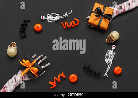 Frame made of gift boxes, skulls and Halloween decoration on black ...