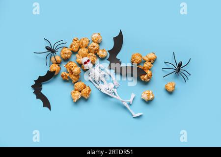 Composition with tasty caramel popcorn and spiders for Halloween ...