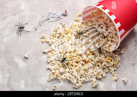 Overturned bucket with popcorn, Halloween decor and movie clapperboard ...