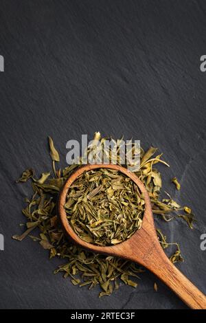 Dried rue leaves in the spoon - Ruta graveolens Stock Photo - Alamy