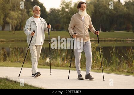 Two senior friends performing Nordic walking outdoors Stock Photo - Alamy