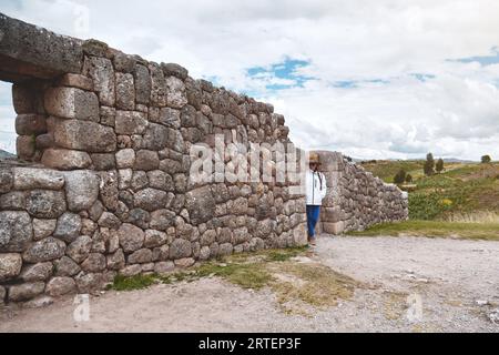 Young woman exploring the Inca's ruins of Pukapukara near Cuzco, Peru ...