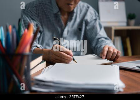 Senior businessman taking notes on notebook, geometric pattern Stock ...