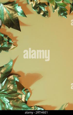 Metallic gold autumn leaves with copy space on orange background Stock ...