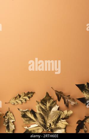 Metallic gold autumn leaves with copy space on orange background Stock ...