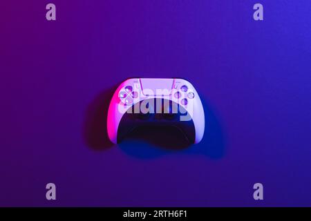 Composite of video game pad and copy space on neon background Stock ...