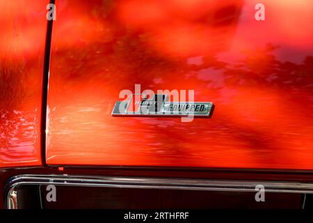 A closeup of the iconic Hurst Equipped emblem on a bright red, glossy ...