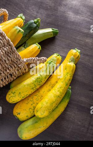 Basket with green zucchinis on wooden table, closeup Stock Photo - Alamy