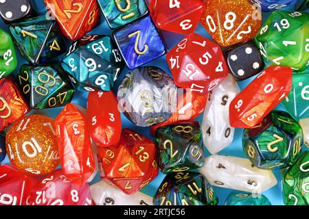 Different colorful role playing dice on table with blurry storage ...