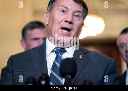 Sen. Mike Rounds (R-S.D.) speaks with reporters as he walks to a vote ...
