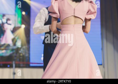 High school graduates dancing waltz and classical ball dance in dresses ...