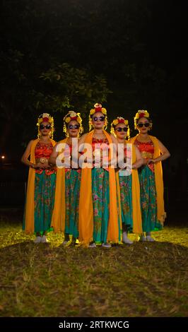 a group of traditional Javanese dancers standing in costumes and orange ...