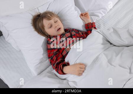 Little boy snoring while sleeping in bed Stock Photo - Alamy