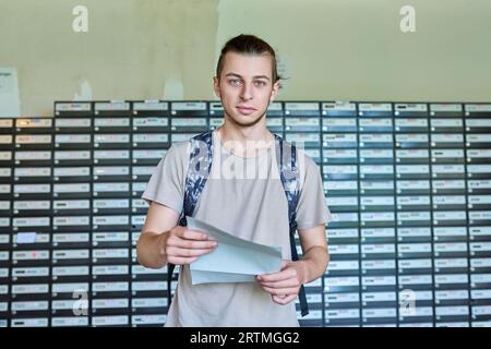 Young guy student reading an important mail letter near mailboxes Stock ...
