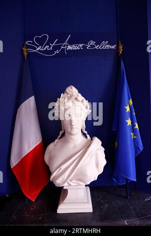 Statue of Marianne with french flag in city hall. Marianne is the ...