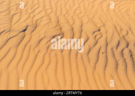 Background waves of sand of reddish color Stock Photo - Alamy