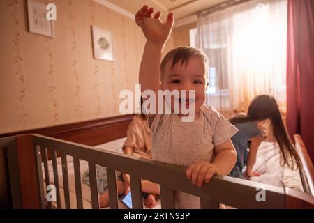 Cute sweet toddler children, tickling feet on the bed, laughing and ...