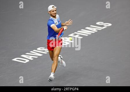 Tomas Machac, of Czech Republic, returns a ball in his first round ...