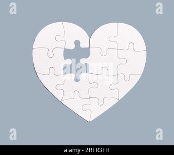 Lacking missing puzzle piece in heart jigsaw Stock Photo - Alamy