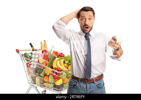 Man holding a shockingly expensive bill isolated on white background ...