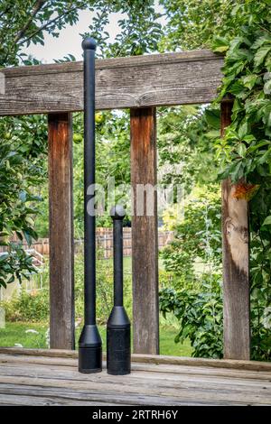 steel mace and clubs on a backyard deck, functional fitness concept ...