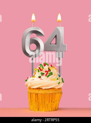 Birthday candle number 64 - Cupcake on white background Stock Photo - Alamy