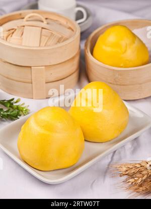 Asian stuffed steamed yellow Bun Bao Stock Photo - Alamy