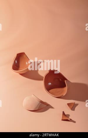 Details of broken ceramic cup on beige background Stock Photo - Alamy