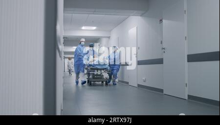 Doctors and nurses run and push stretcher with seriously injured ...