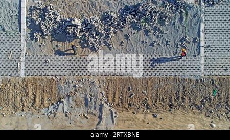 Workers are building river slope protection at a water conservancy ...