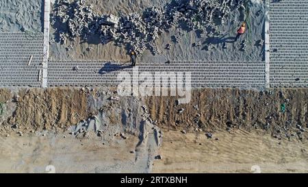 Workers are building river slope protection at a water conservancy ...