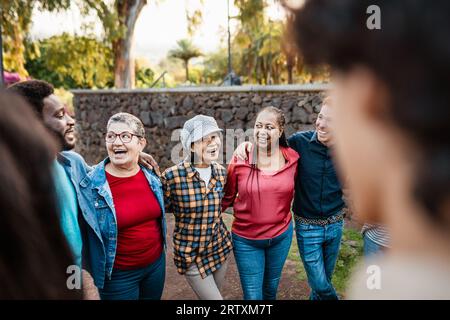 Group of multigenerational people smiling in front of camera - Multiracial friends od different ...