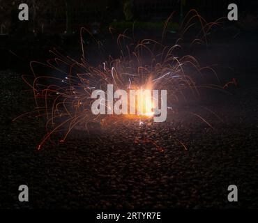 Red ground fireworks on asphalt Stock Photo - Alamy