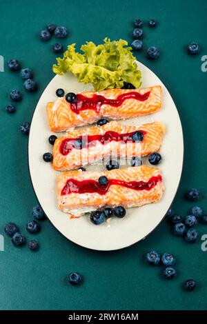 Baked salmon fish with blueberry berry sauce. Salmon fillets, grilled ...