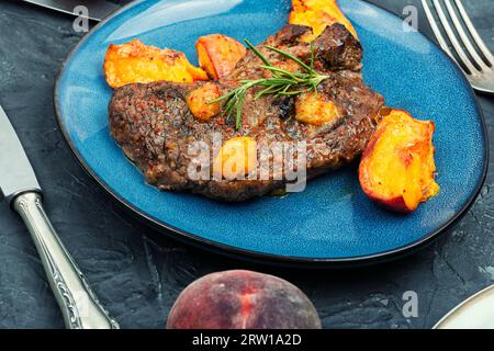 Diet baked beef steak with peach. Space for text Stock Photo - Alamy