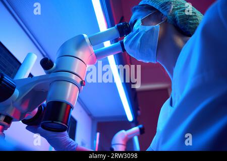 Embryologist uses a powerful microscope in her work Stock Photo - Alamy