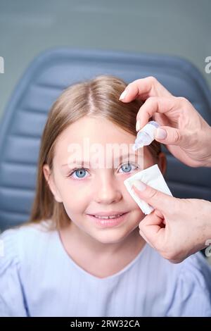 Pediatric eye doctor preparing child for visual acuity test Stock Photo ...
