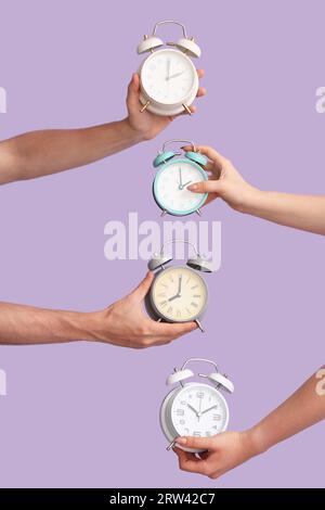 Hands holding different alarm clocks on blue background Stock Photo - Alamy