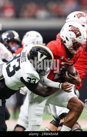 UNLV quarterback Doug Brumfield (2) is sacked by Michigan defensive ...