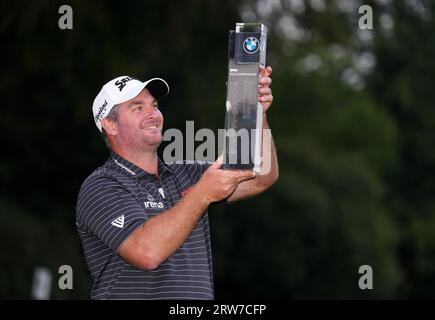Ryan Fox poses with the championship trophy along with his wife Anneke ...