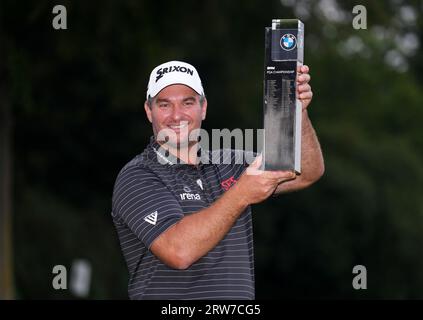 Ryan Fox poses with the championship trophy along with his wife Anneke ...