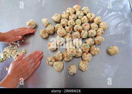 Workers are making moon cake stuffing by hand in a food processing ...