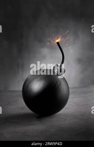 An old fashioned style round bomb with a lit fuse about to explode ...