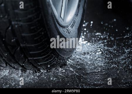 Car tire splashing in water Stock Photo - Alamy