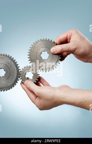 Man designing a mechanic system with old metallic cog gear wheels Stock ...