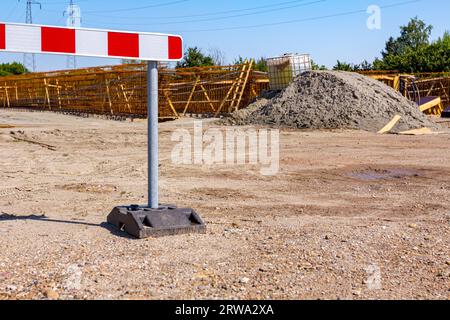 Work in progress, boundary sign with red and white stripes set on the ...