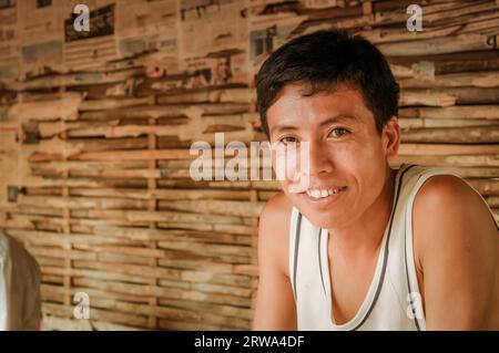 Damak, Nepal, circa May 2012: Native man in checked blue and red shirt ...