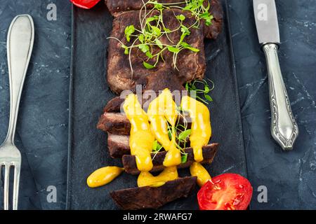 Roasted ostrich meat steaks with sauce. African cuisine Stock Photo - Alamy